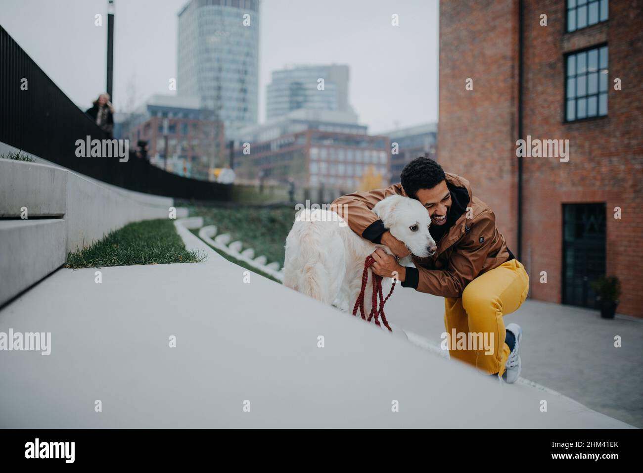 Young man embracing labrador hi-res stock photography and images - Alamy