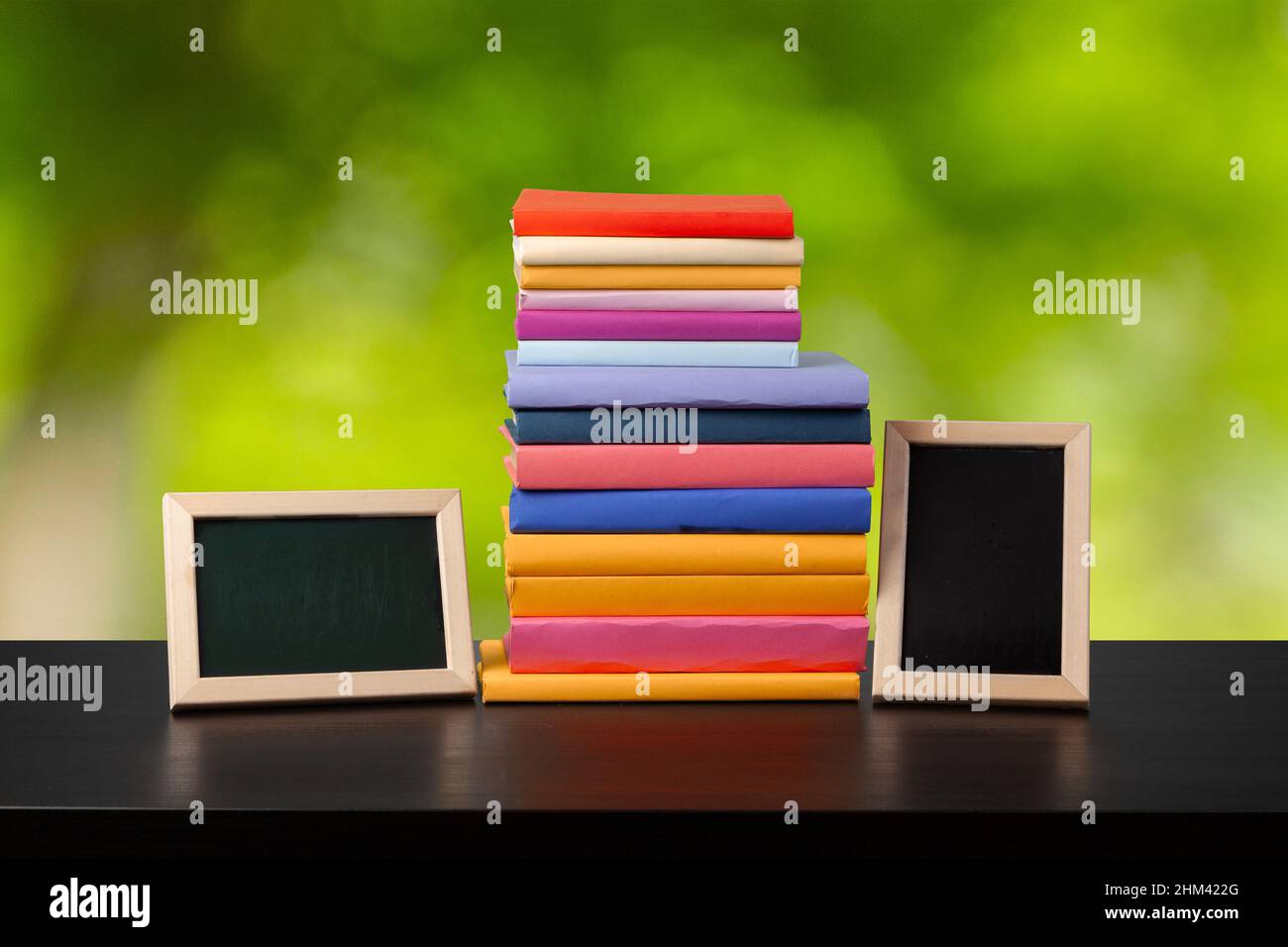 Stack of books on wooden table against blurred background Stock Photo ...