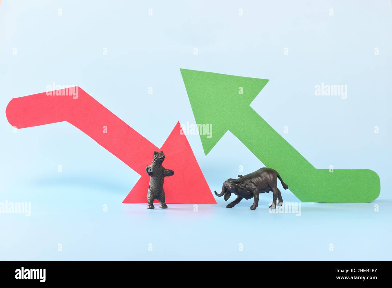 Red downward arrow and green upward arrow beside a bear and bull animal ...
