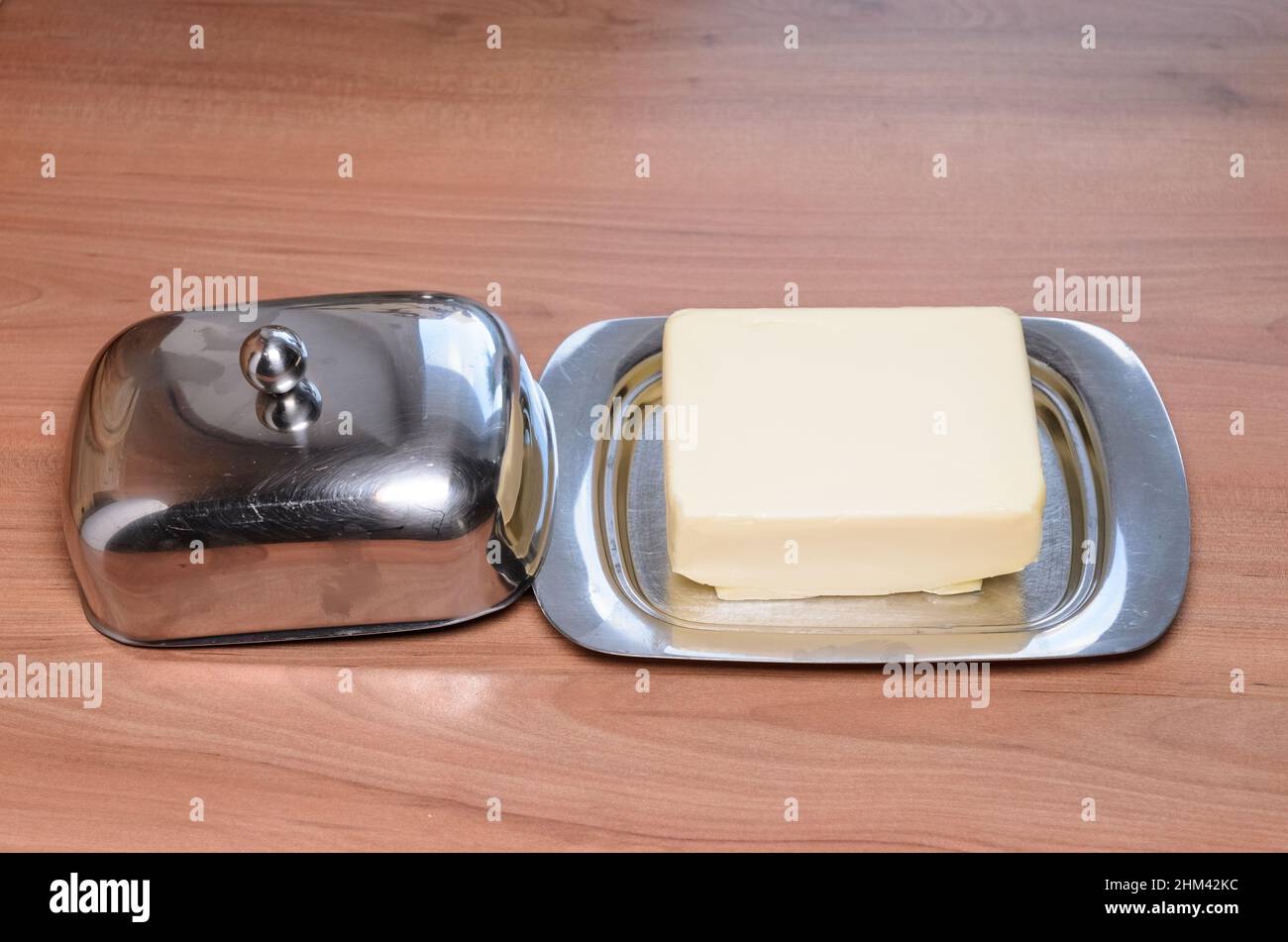 Metal butter dish on wooden desk in the kitchen, view from above Stock ...