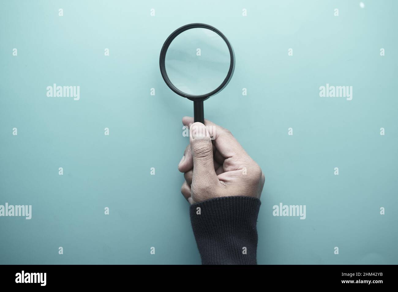 Hand holding magnifying glass reading hi-res stock photography and ...