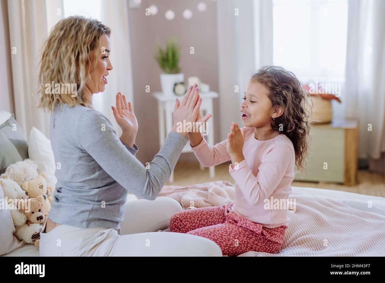 Mother and daughter playing hand clap hi-res stock photography and images - Alamy
