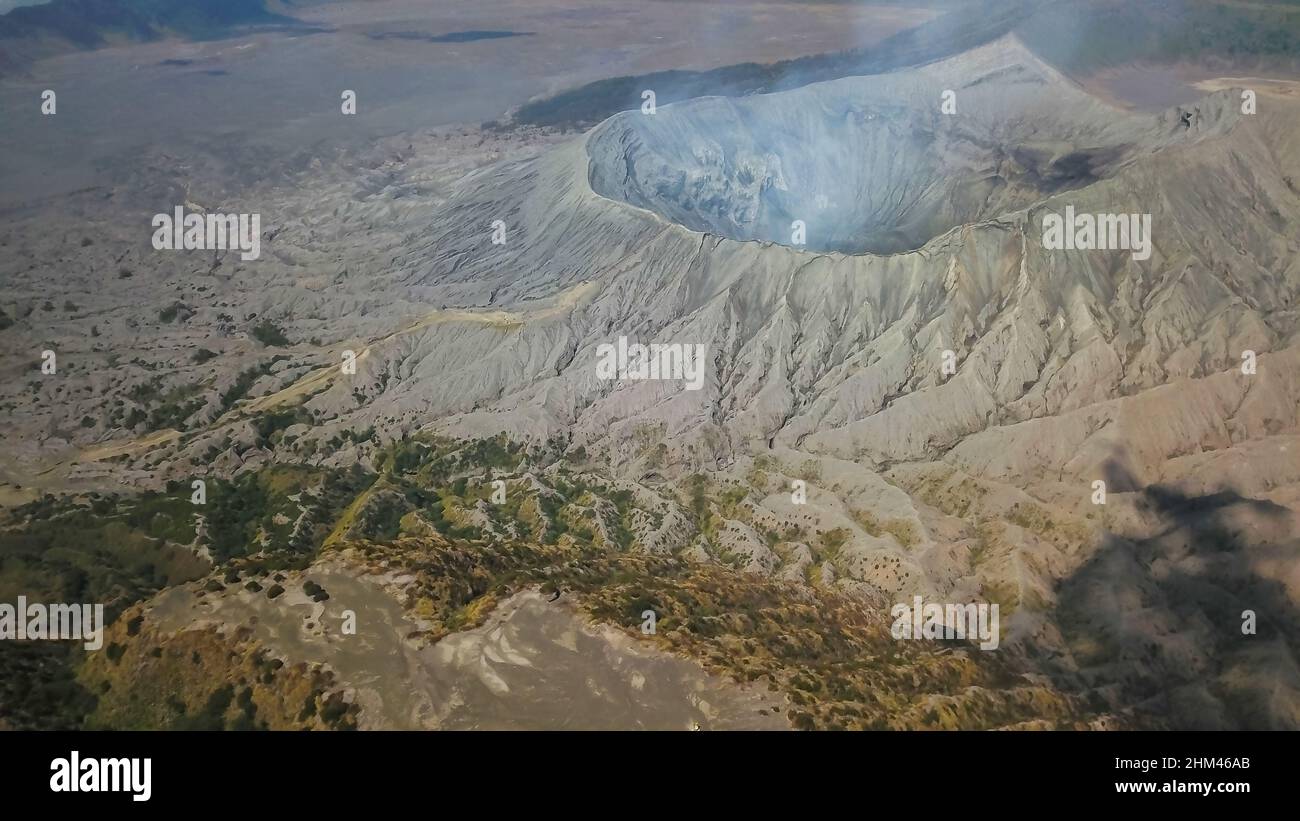View from above, stunning aerial view of the Mount Bromo with clouds of ...