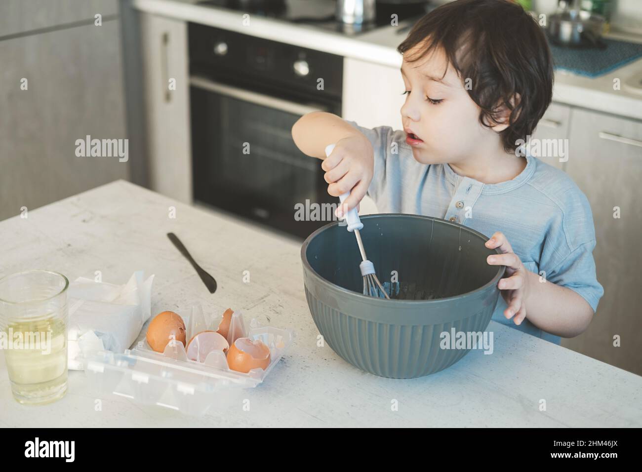 A little boy is cooking in the kitchen Stock Photo - Alamy