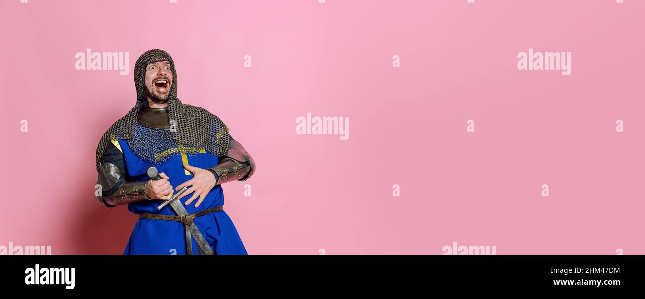 Portrait of laughing man, medieval warrior or knight in armor with ...