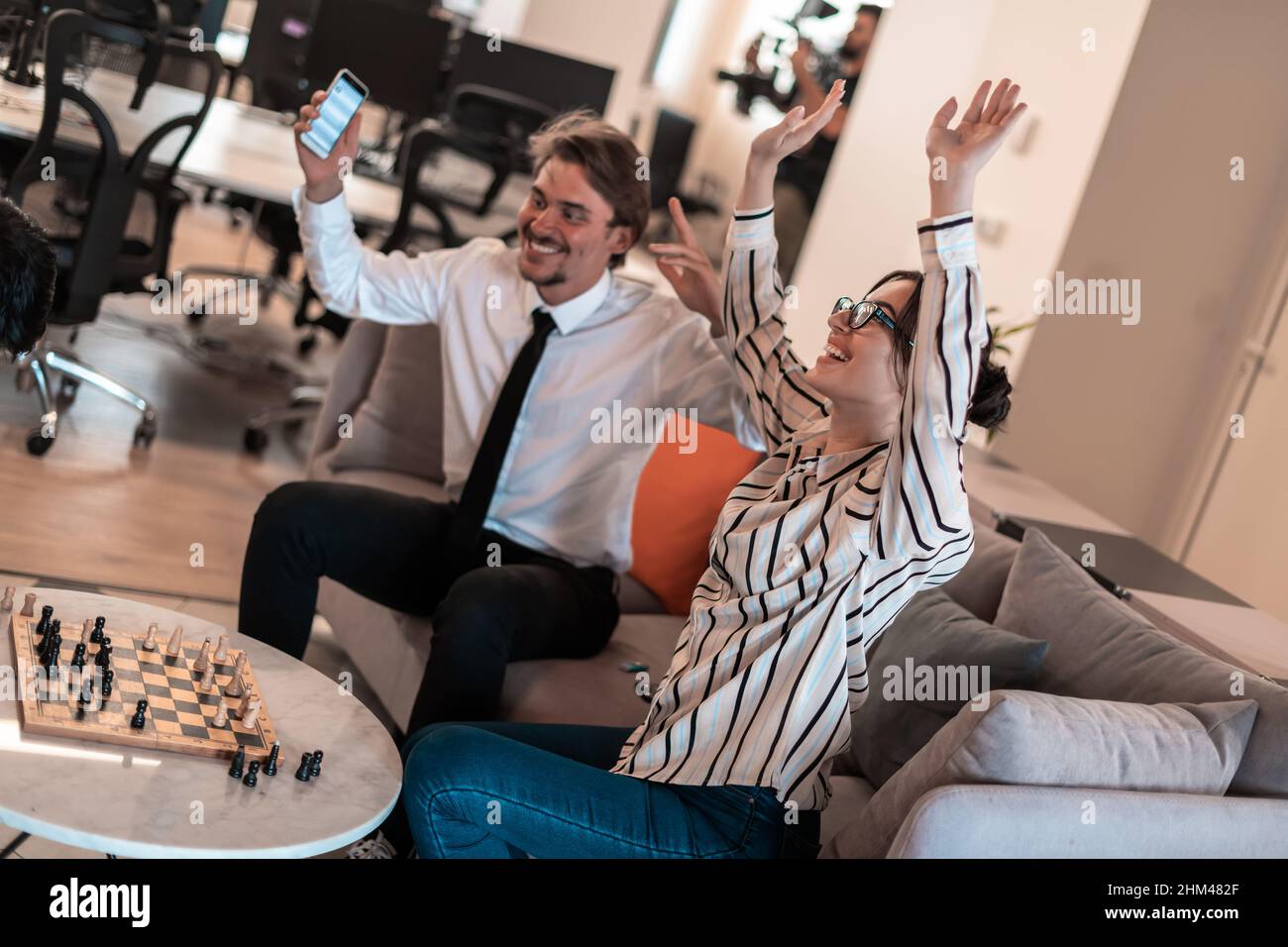 Multiethnic group of business people playing chess while having a break ...