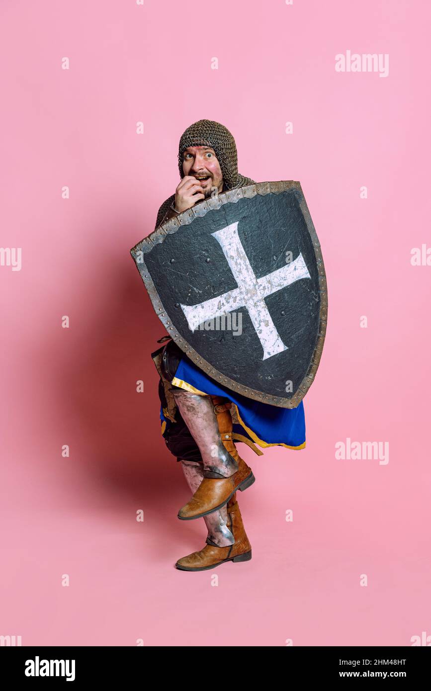Man hiding behind shield hi-res stock photography and images - Alamy