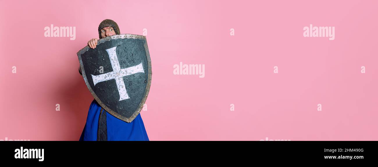 Portrait of scary man, medieval warrior or knight in armor hiding ...