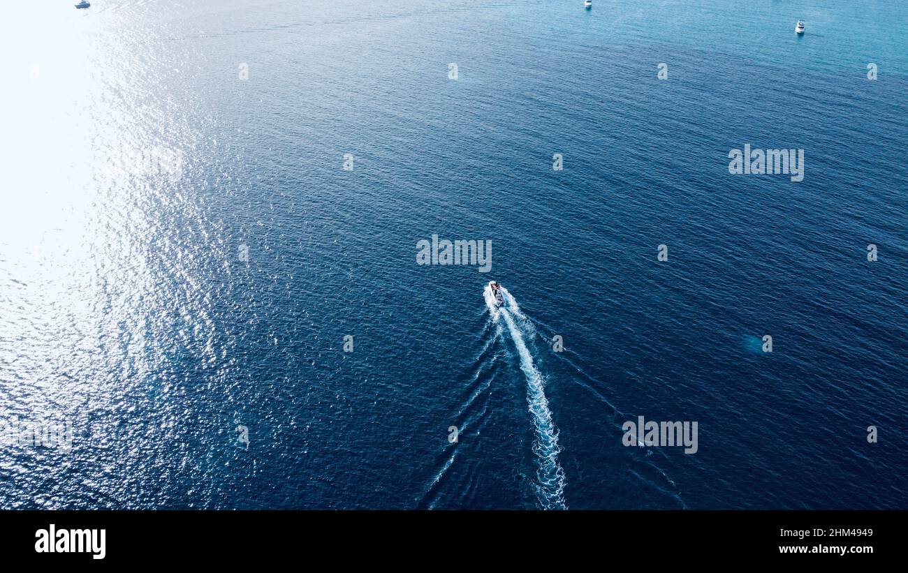 Boat on a bleu sea Stock Photo - Alamy