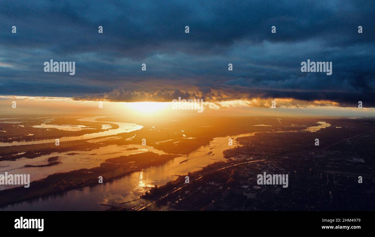 Low hanging clouds above river during sunset Stock Photo - Alamy