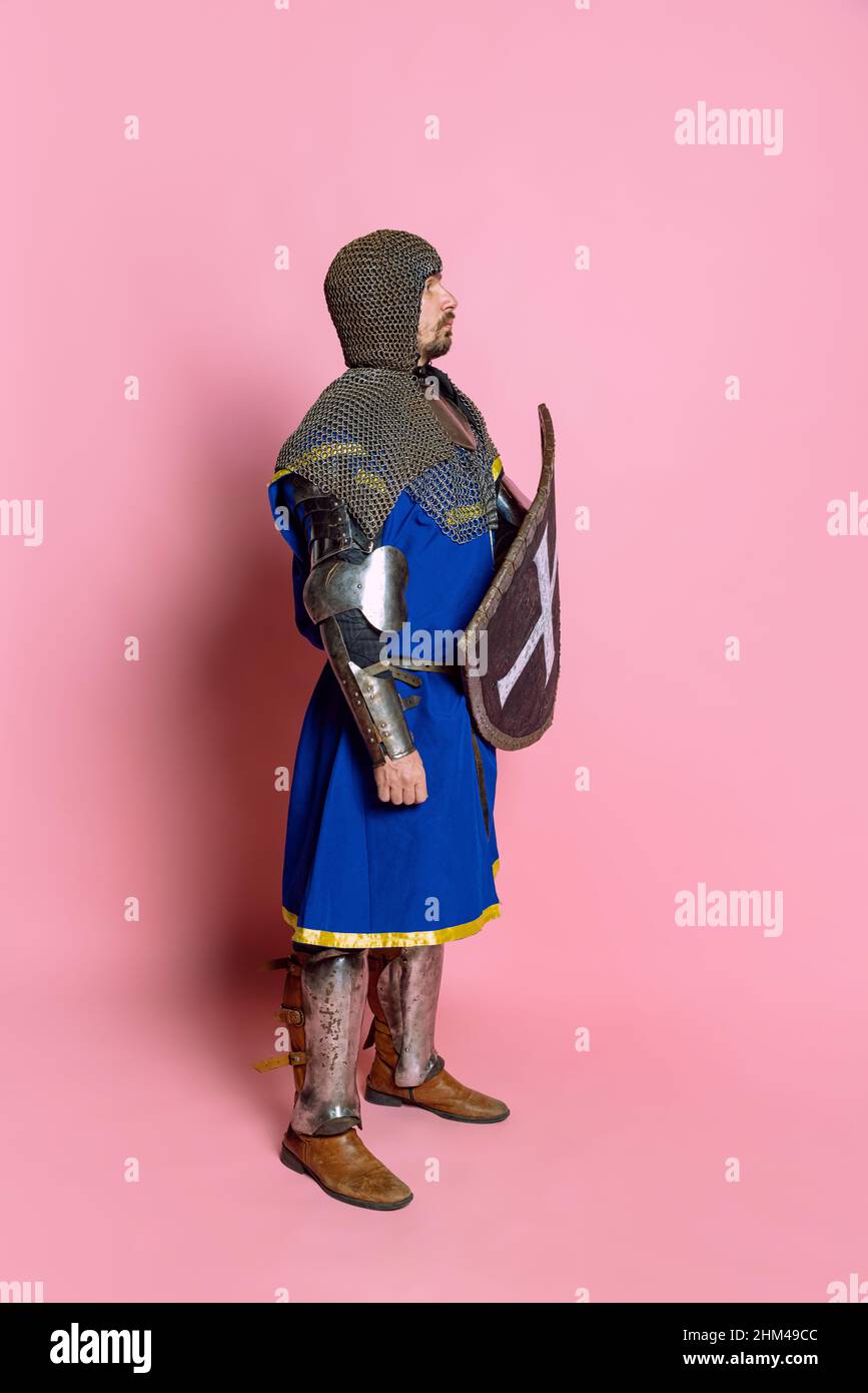Side view full-length portrait of brave man, medieval warrior or knight ...