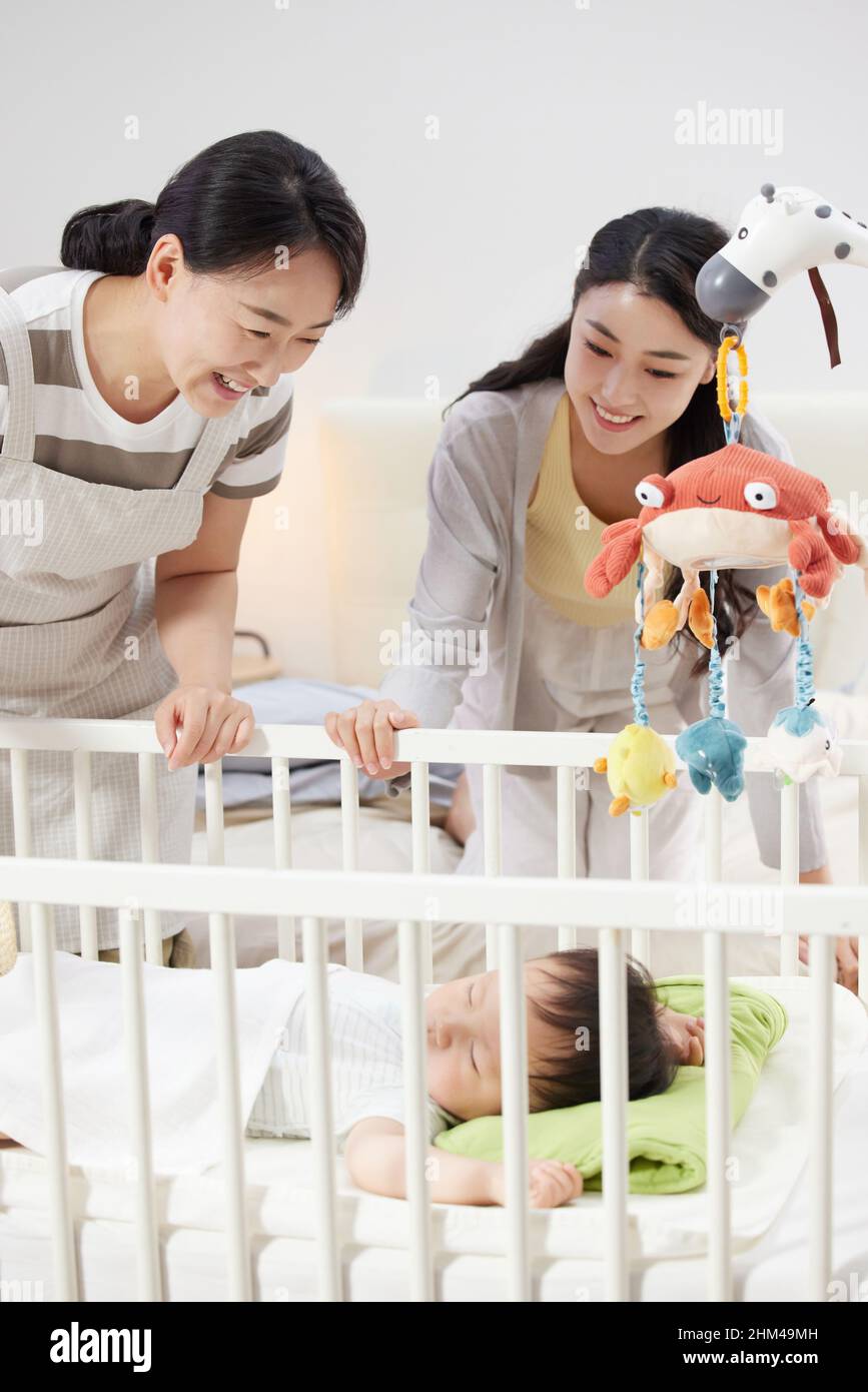 Nanny and young mother to take care of the baby Stock Photo - Alamy
