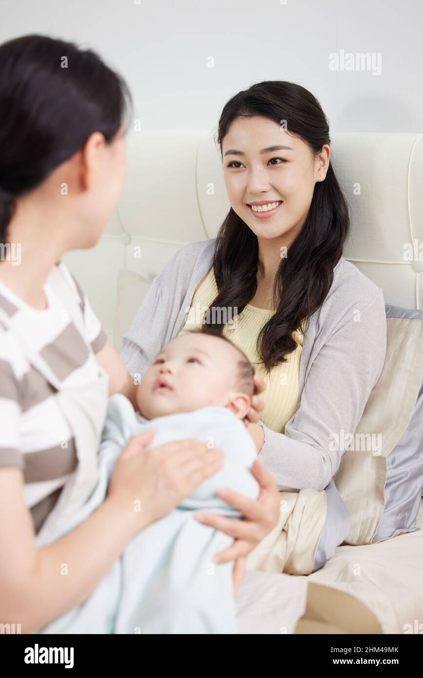 Nanny and young mother to take care of the baby Stock Photo - Alamy