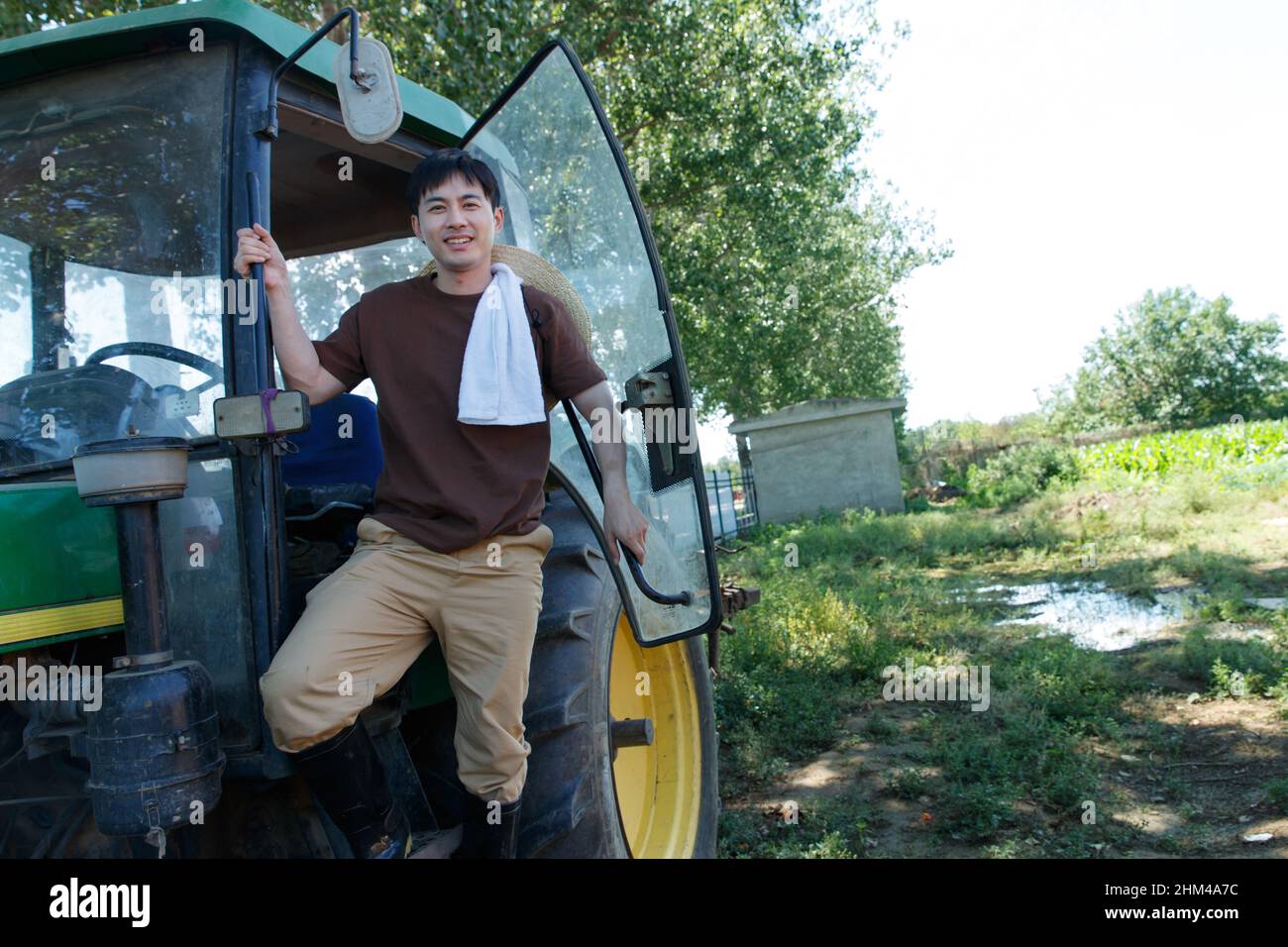 Farmers driving harvester Stock Photo - Alamy