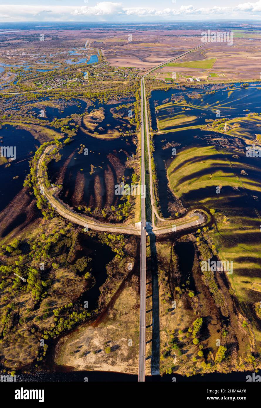 Road across flooded floodplains meadows from above. Pripyat river delta ...