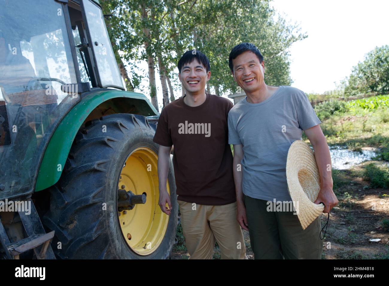 Farmland harvester by farmers Stock Photo - Alamy
