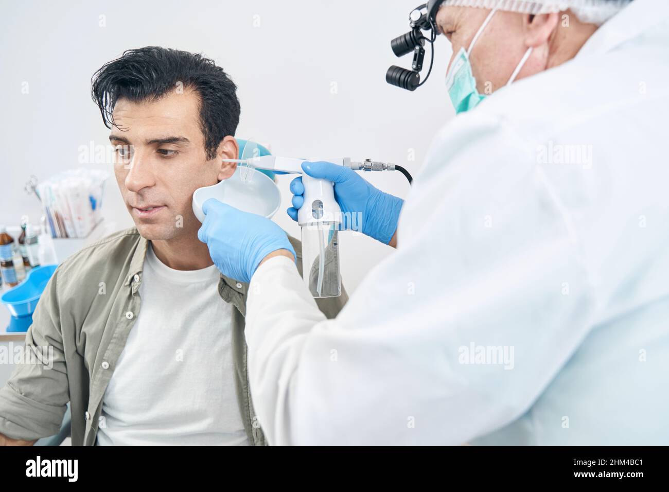 Medical worker providing treatment for adult patient Stock Photo - Alamy