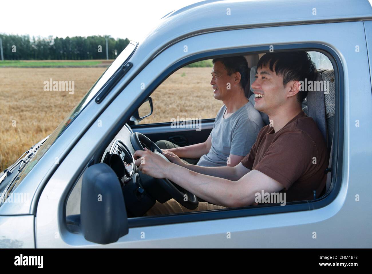Farmers driving agricultural vehicles Stock Photo - Alamy