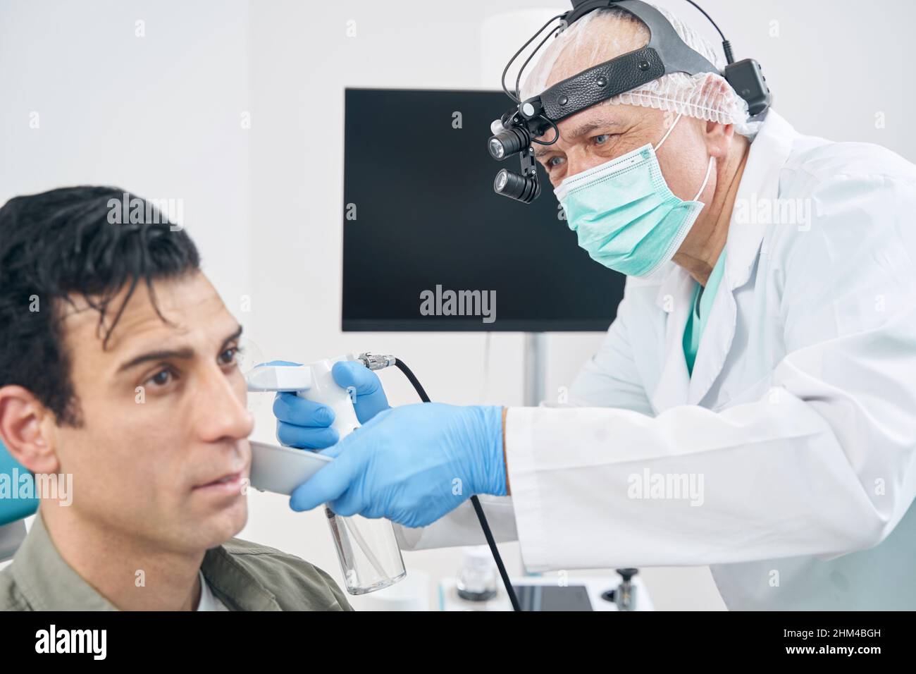 Medical worker providing treatment for adult male Stock Photo - Alamy