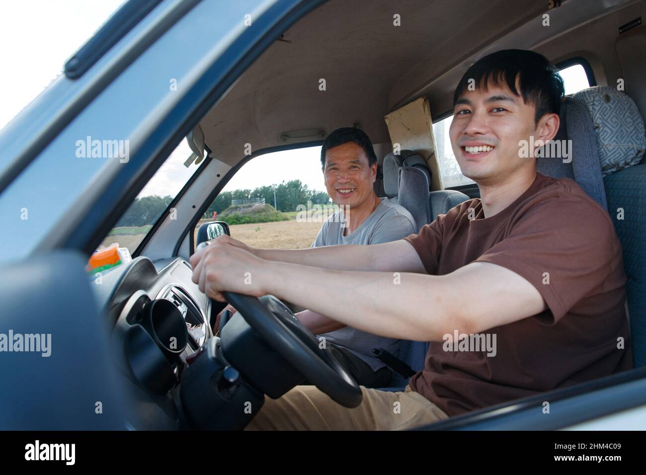 Farmers driving agricultural vehicles Stock Photo - Alamy