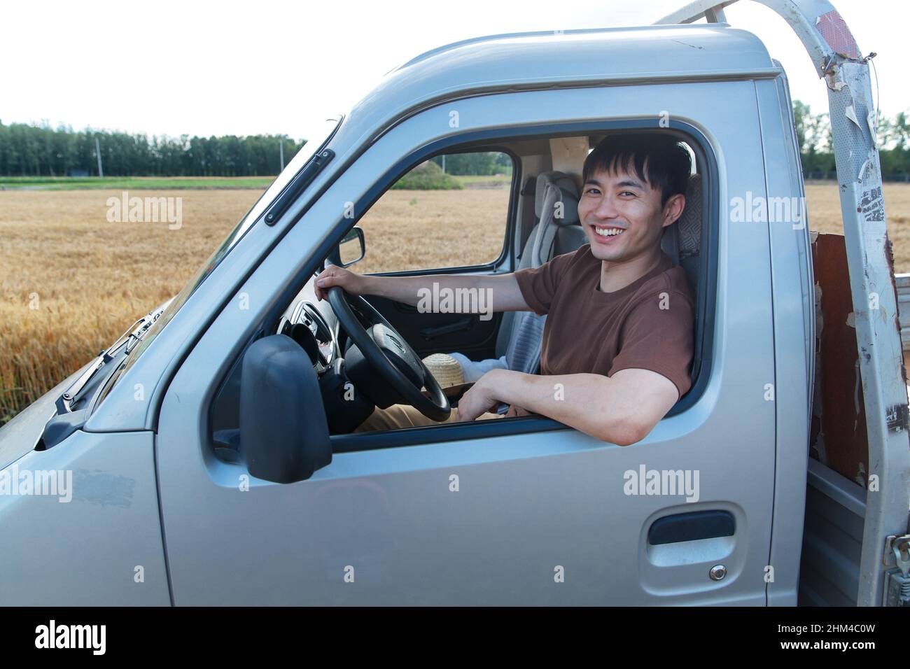 Farmers driving agricultural vehicles Stock Photo - Alamy