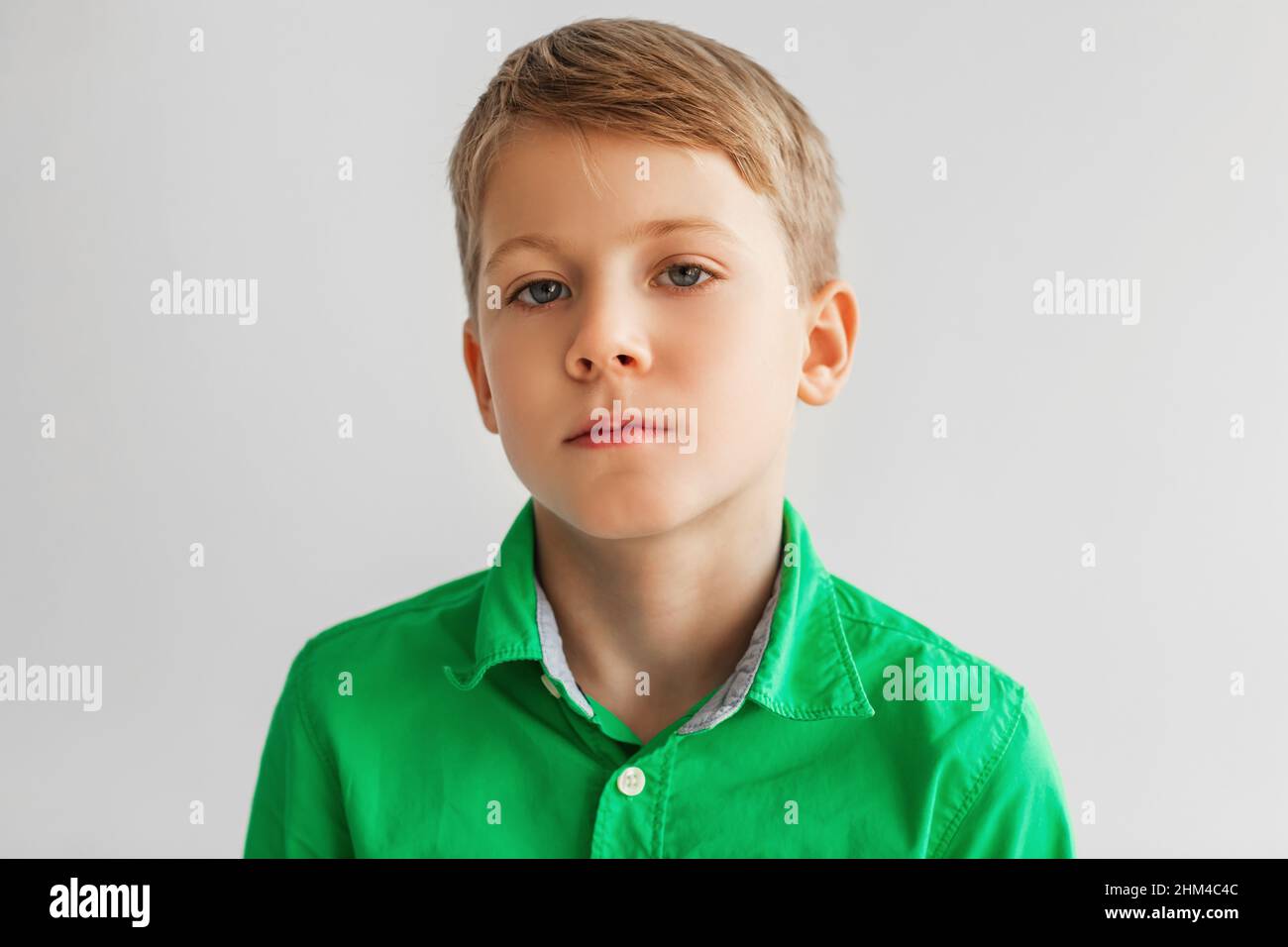 Headshot Of Serious Blonde Boy Looking At Camera, Gray Background Stock ...