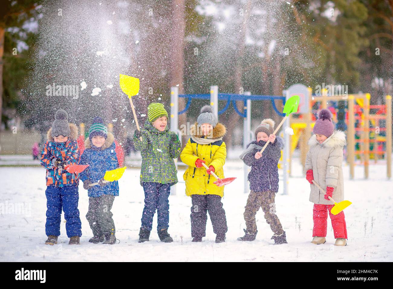 A group of children in the winter park plays and has fun, boys and ...