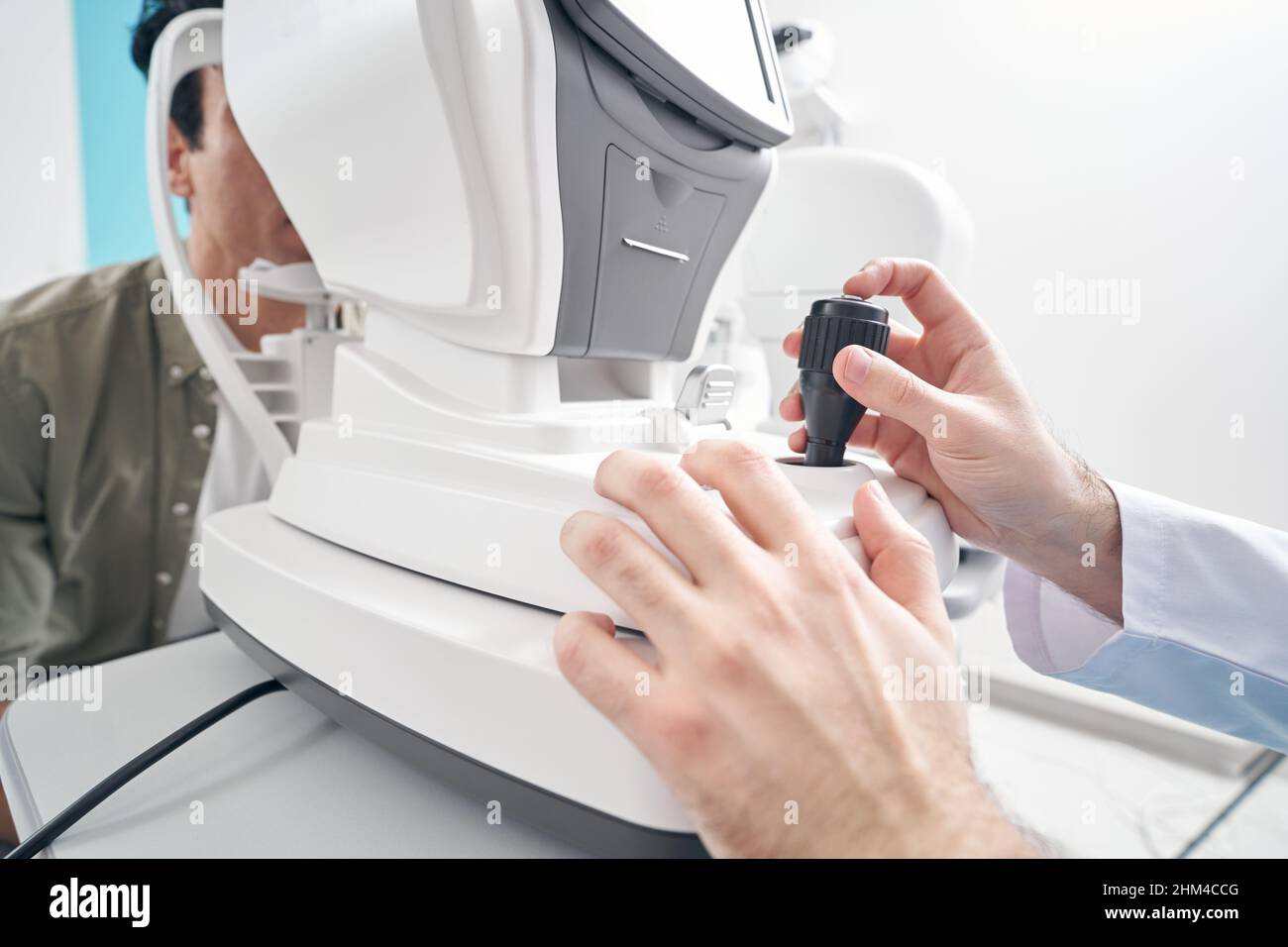 Adult doctor working at the refraction machine Stock Photo - Alamy