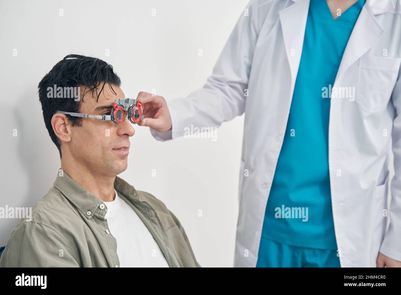 Professional doctor diagnosing vision of man at the hospital Stock ...
