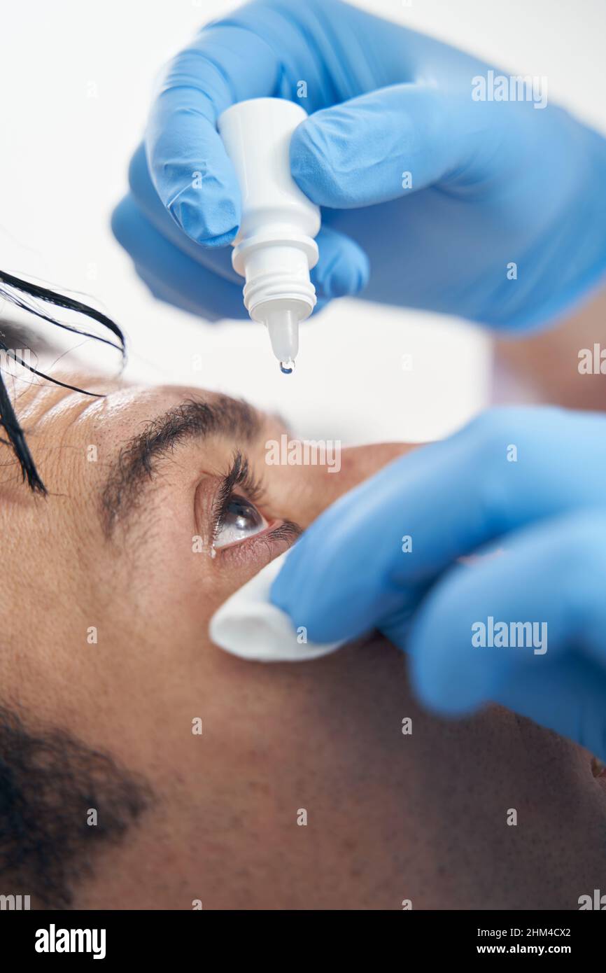 Professional ophthalmologist conducts eye treatment with medicine Stock ...
