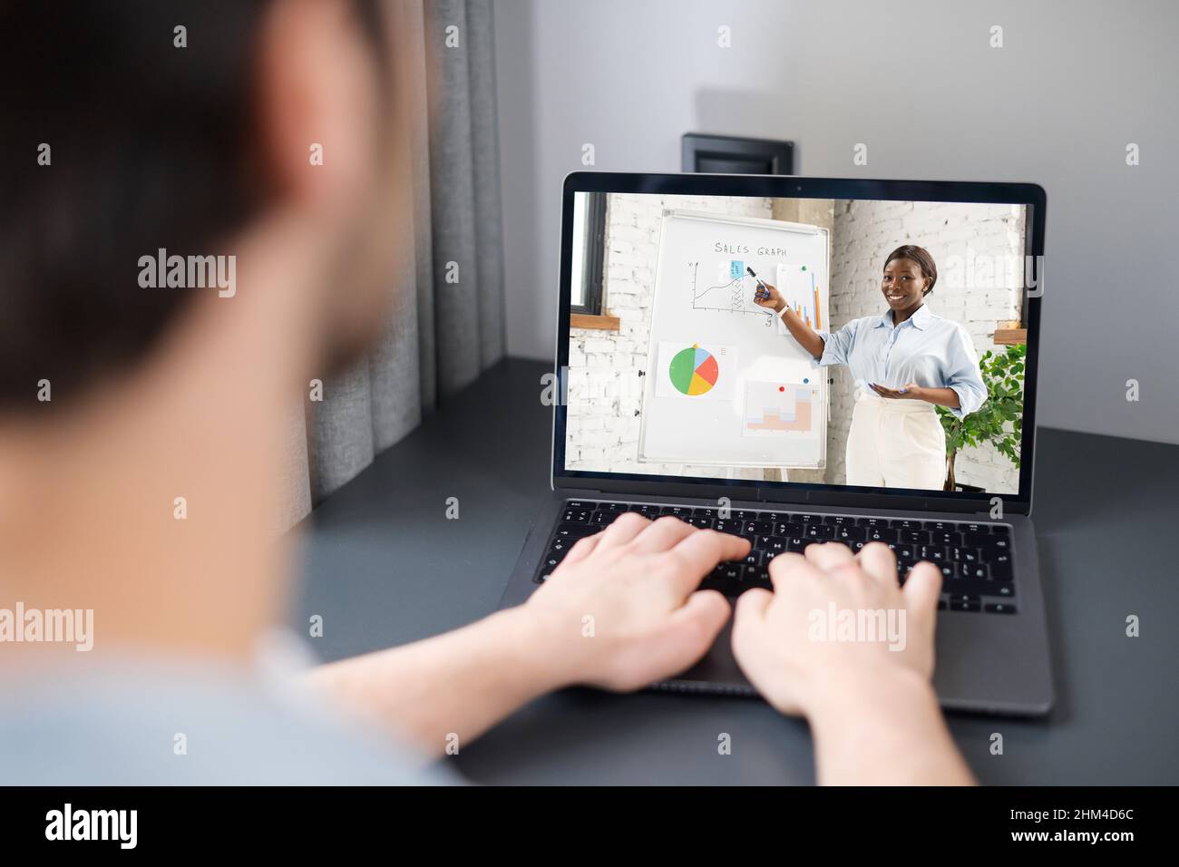 Male student using app for distance video communication with female ...