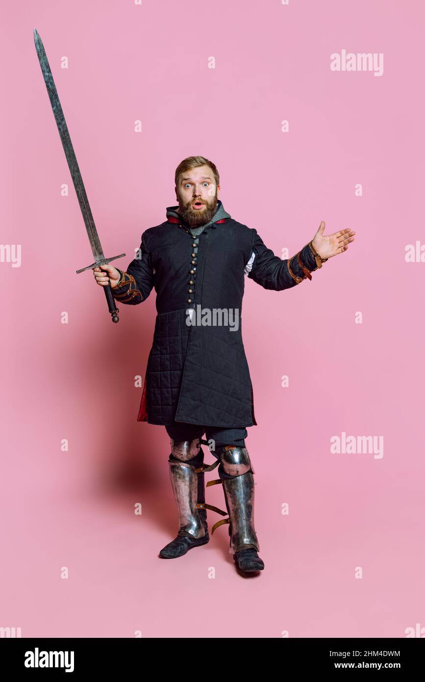 Full-length portrait of young bearded man, medieval warrior or archer ...