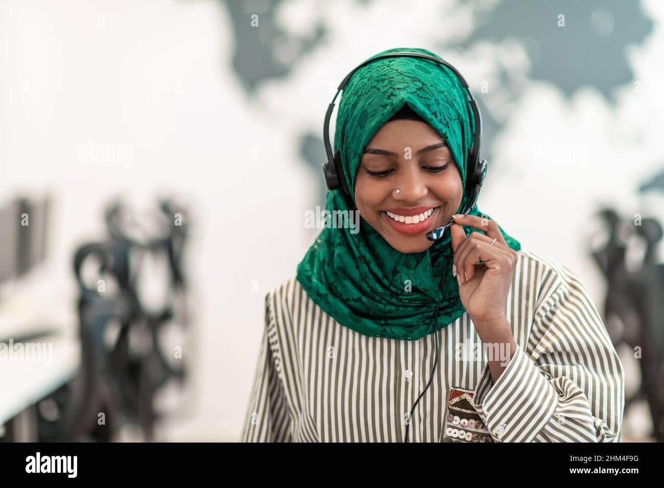 Afro Muslim female with green hijab scarf customer representative ...