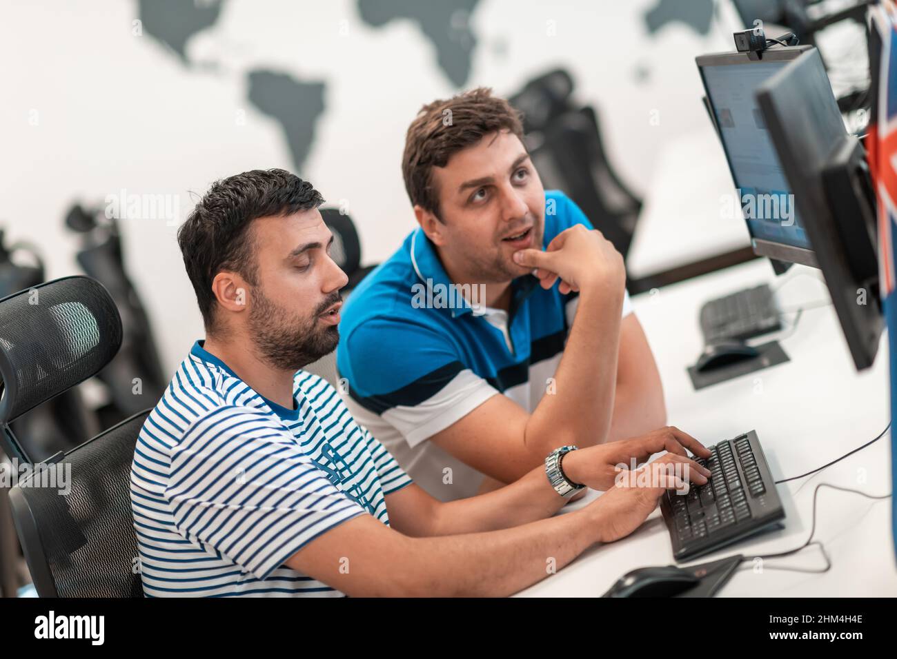Group of Casual business man working on desktop computer in modern open ...