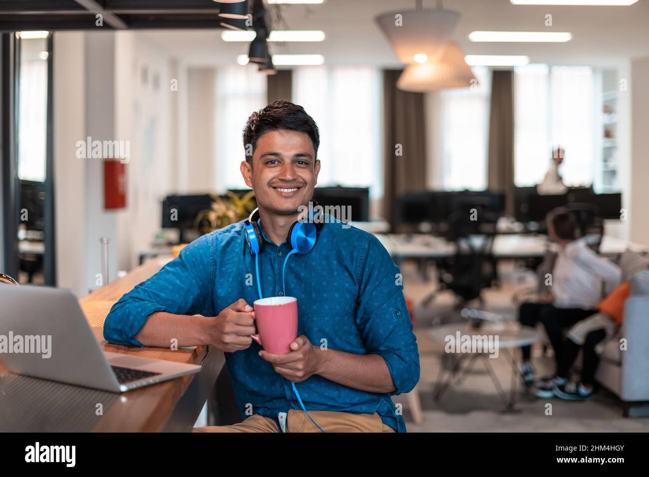 Casual business man taking break from the work using laptop while ...