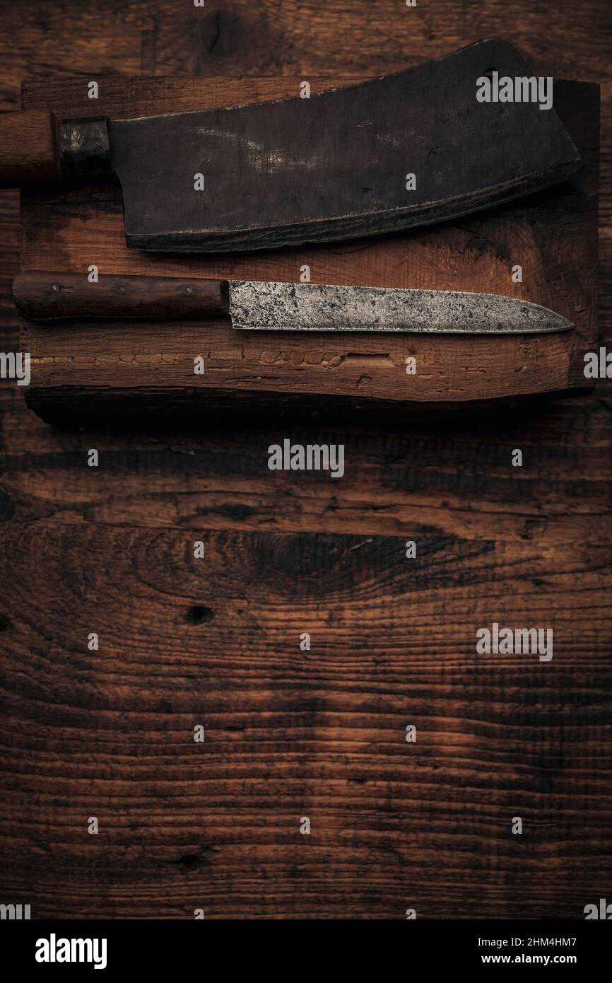 vintage utility knife and big rusty bones cleaver on and old piece of ...