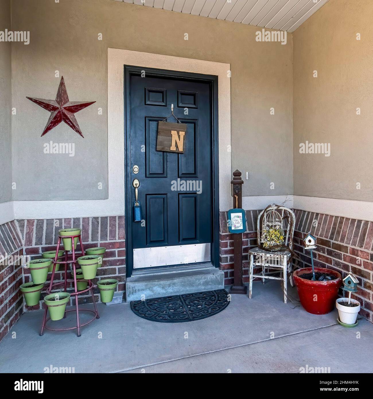 Square Front door exterior with decorative displays and pots Stock ...