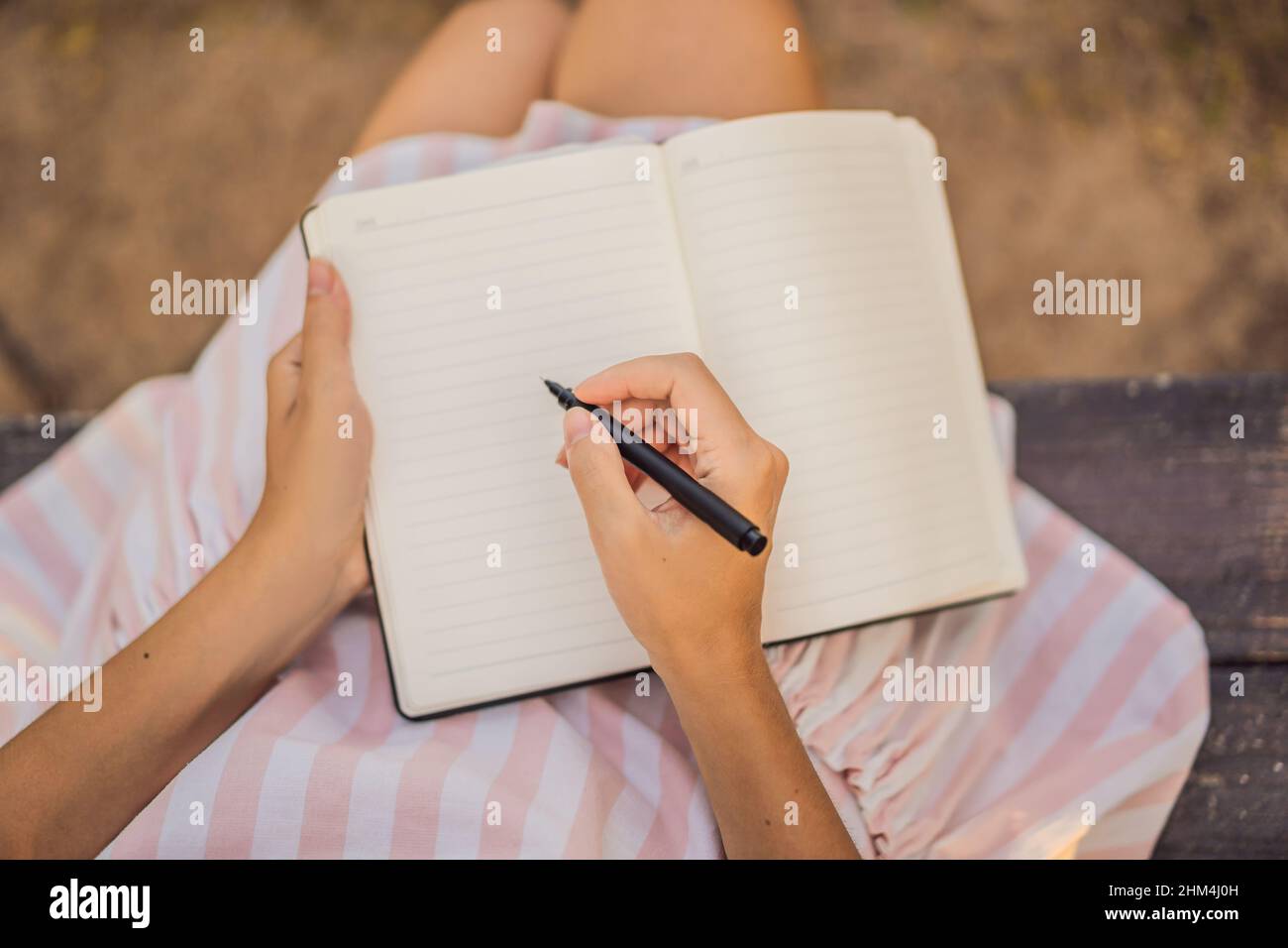 Women's hands in a tropical background holding a signboard, drawing ...