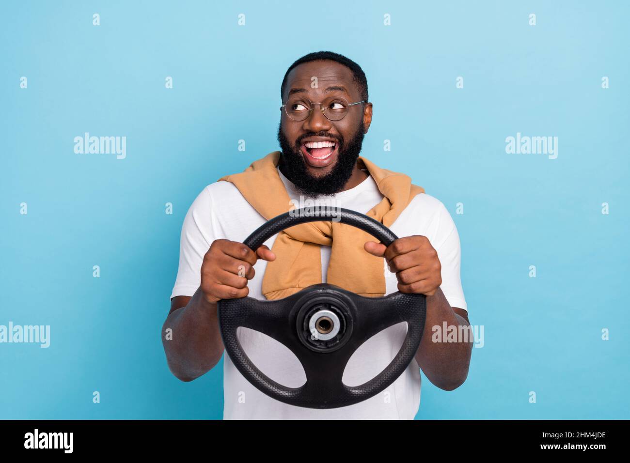 Photo of funny driver hold steering wheel look empty space wear white t ...