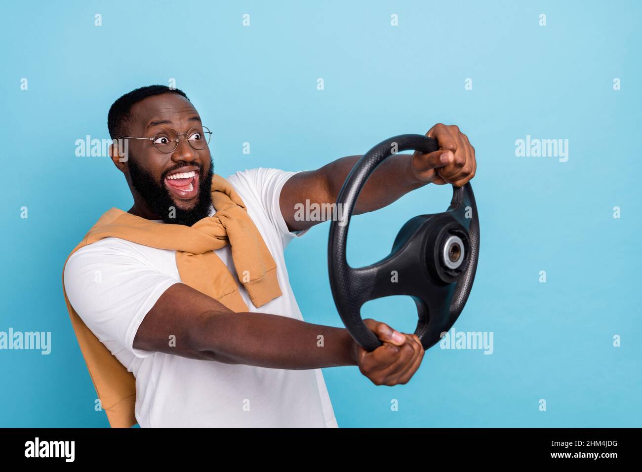 Photo of screaming smiling man riding car fast speed traveling have fun carefree isolated on ...