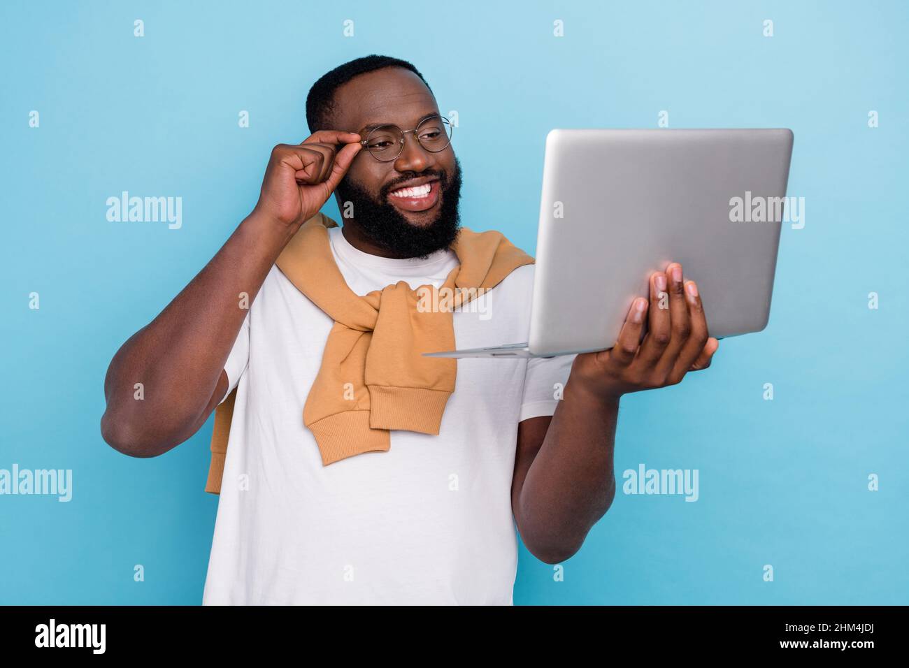 Photo of smiling good mood businessman in glasses working in laptop ...