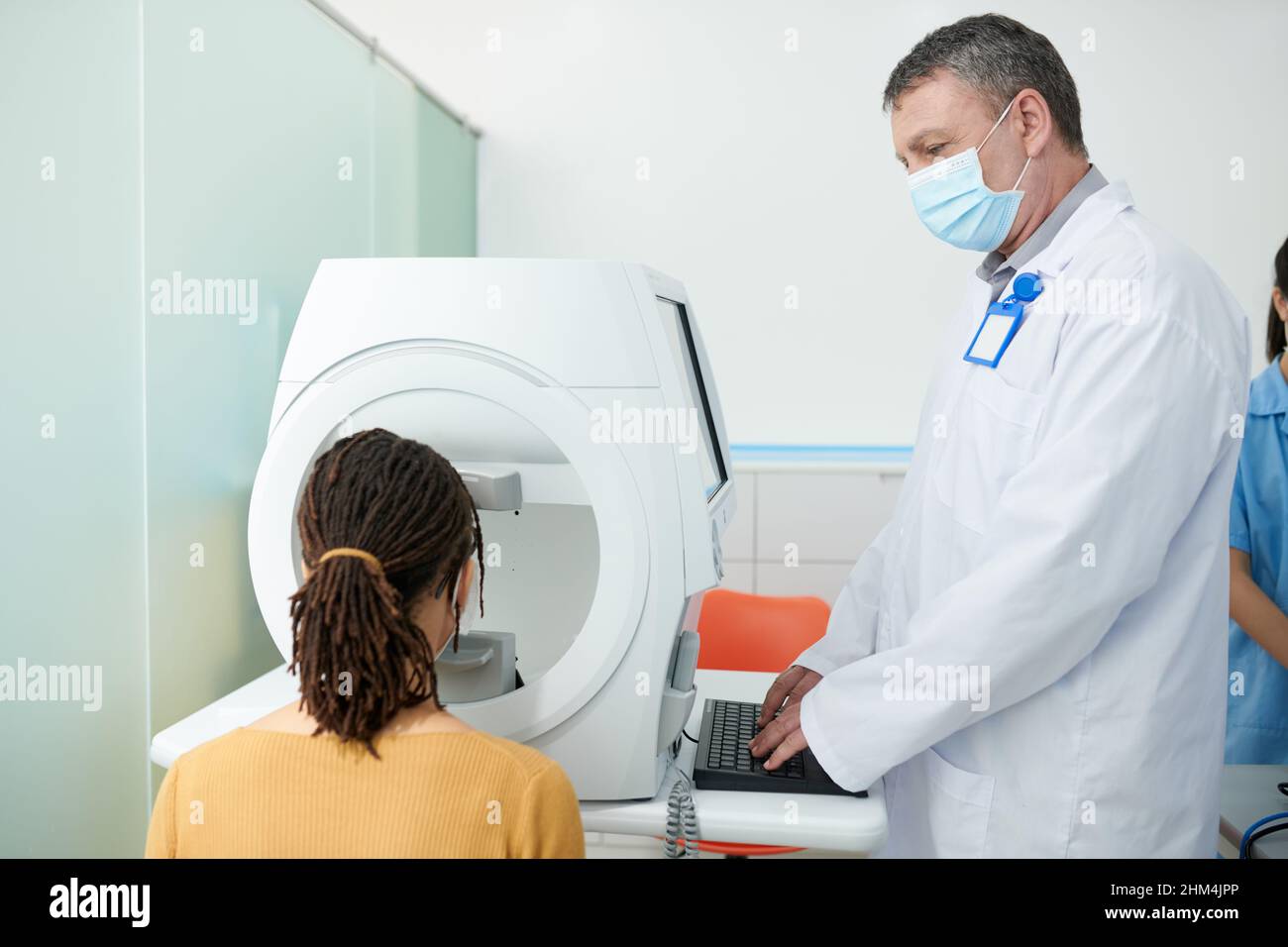 Doctor using automated refractor that provides objective measurement of ...