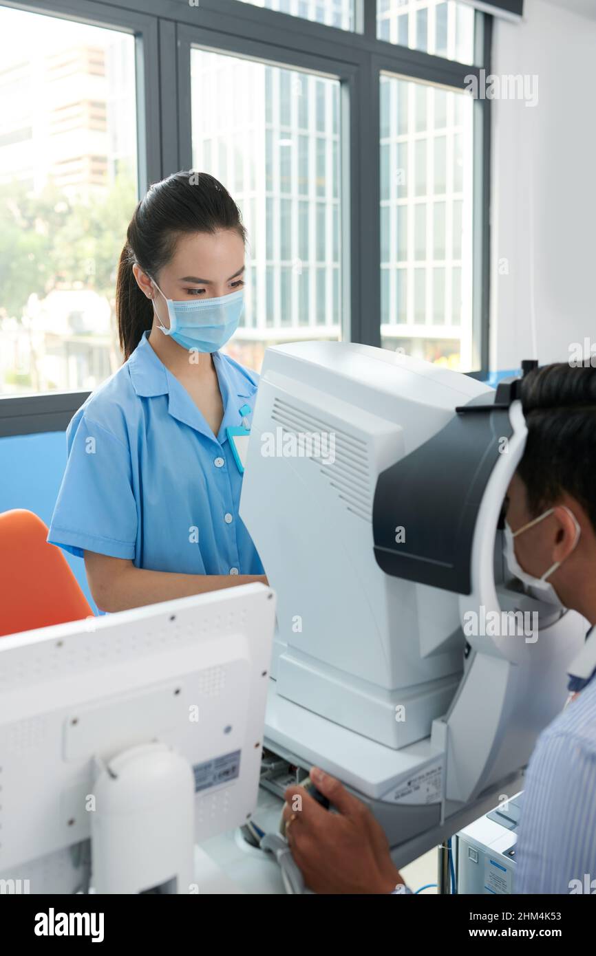 Young doctor using air -puff tonometer to determine intraocular ...