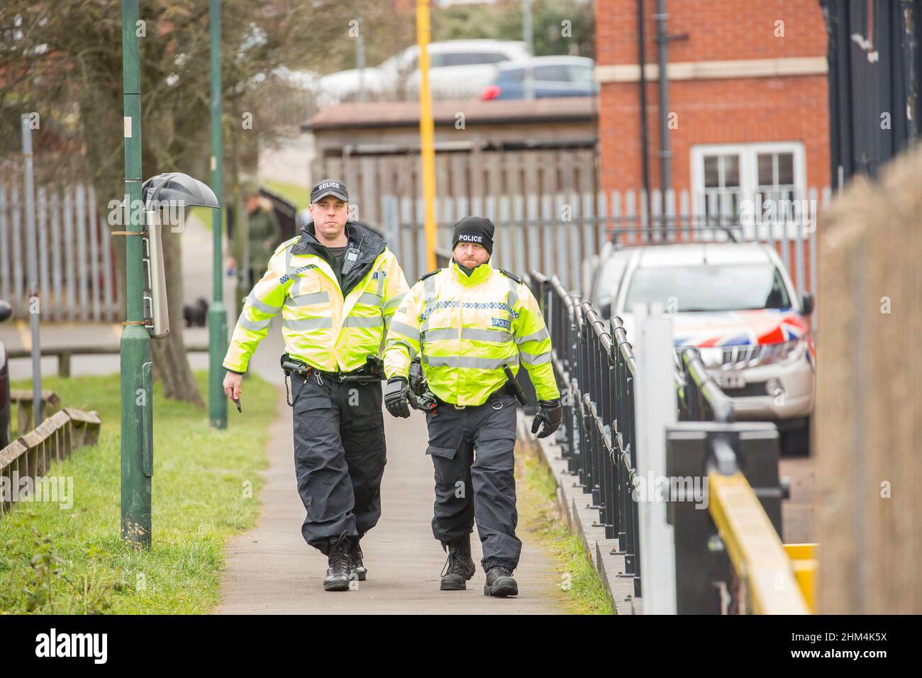 Front view of two police officers walking forward Stock Photo - Alamy