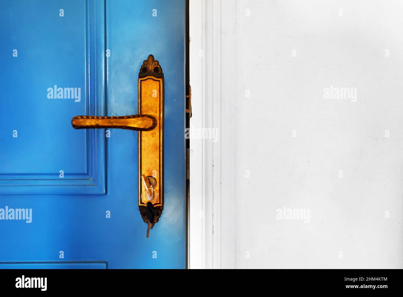 Blue front door with gilded lock and handle Stock Photo - Alamy