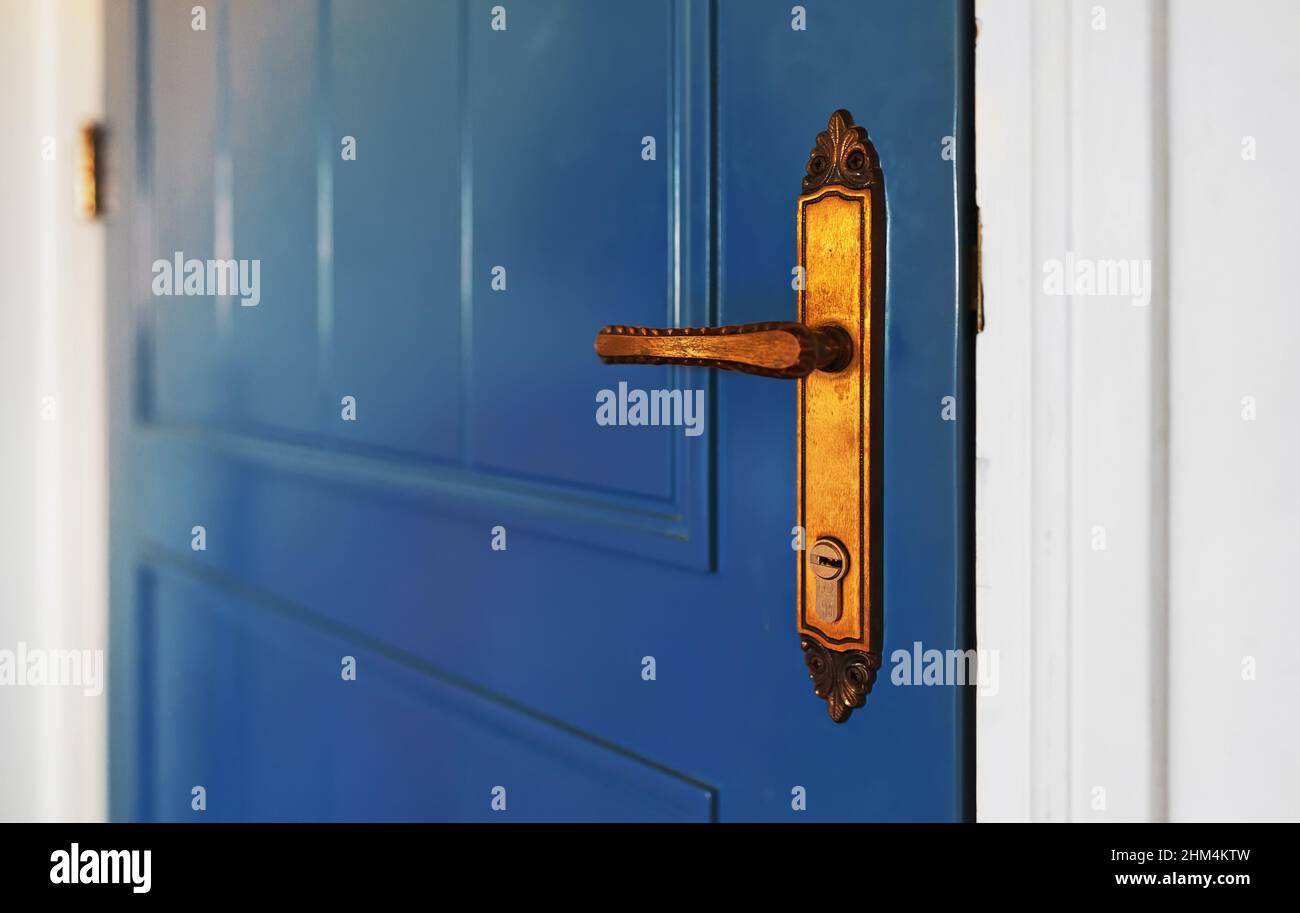 Blue front door with gilded lock and handle Stock Photo - Alamy