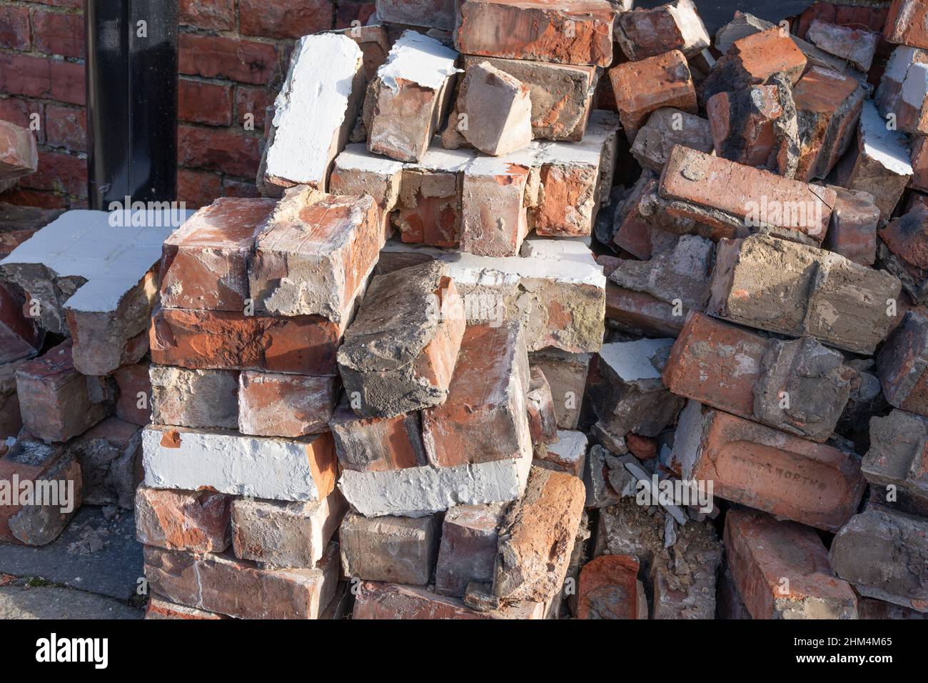 A pile of bricks from a collapsed wall in a back lane, following storms ...