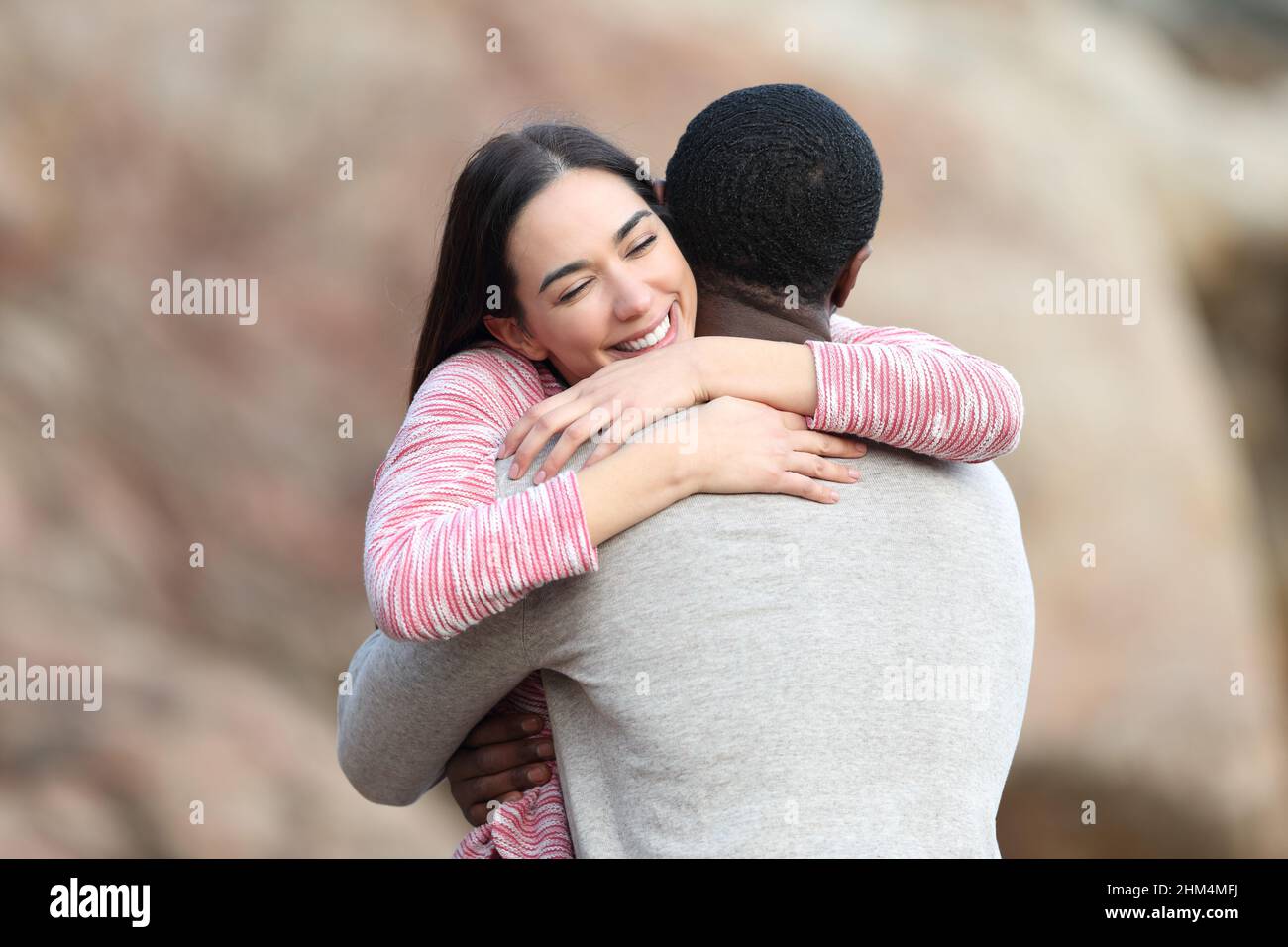 Happy affectionate woman hugging a man outdoors in a date Stock Photo ...