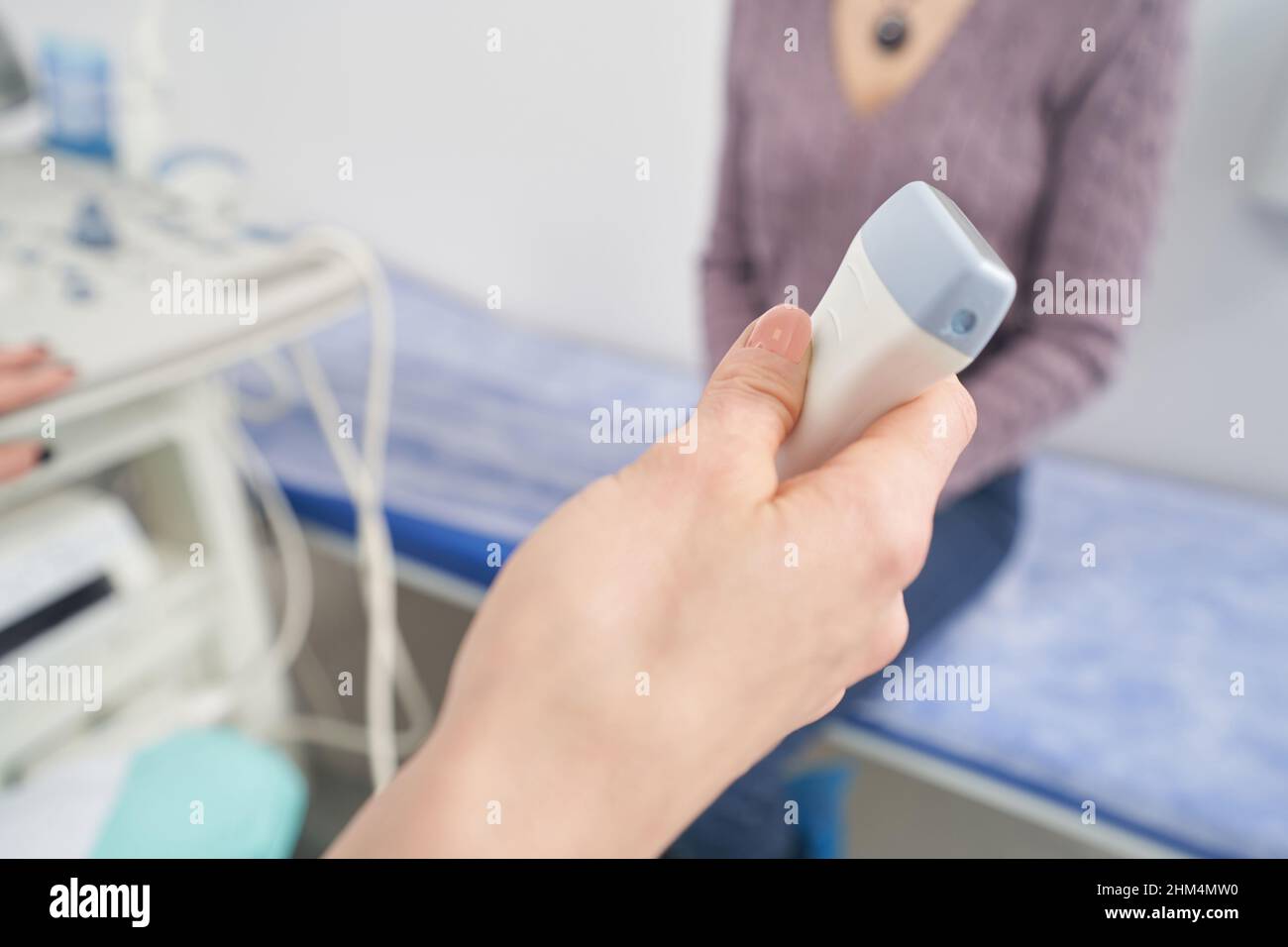 Diagnostician preparing woman for ultrasound examination procedure ...