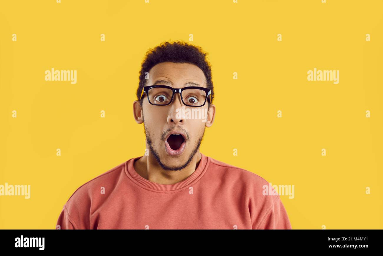 Young man with funny surprised and shocked facial expression isolated ...